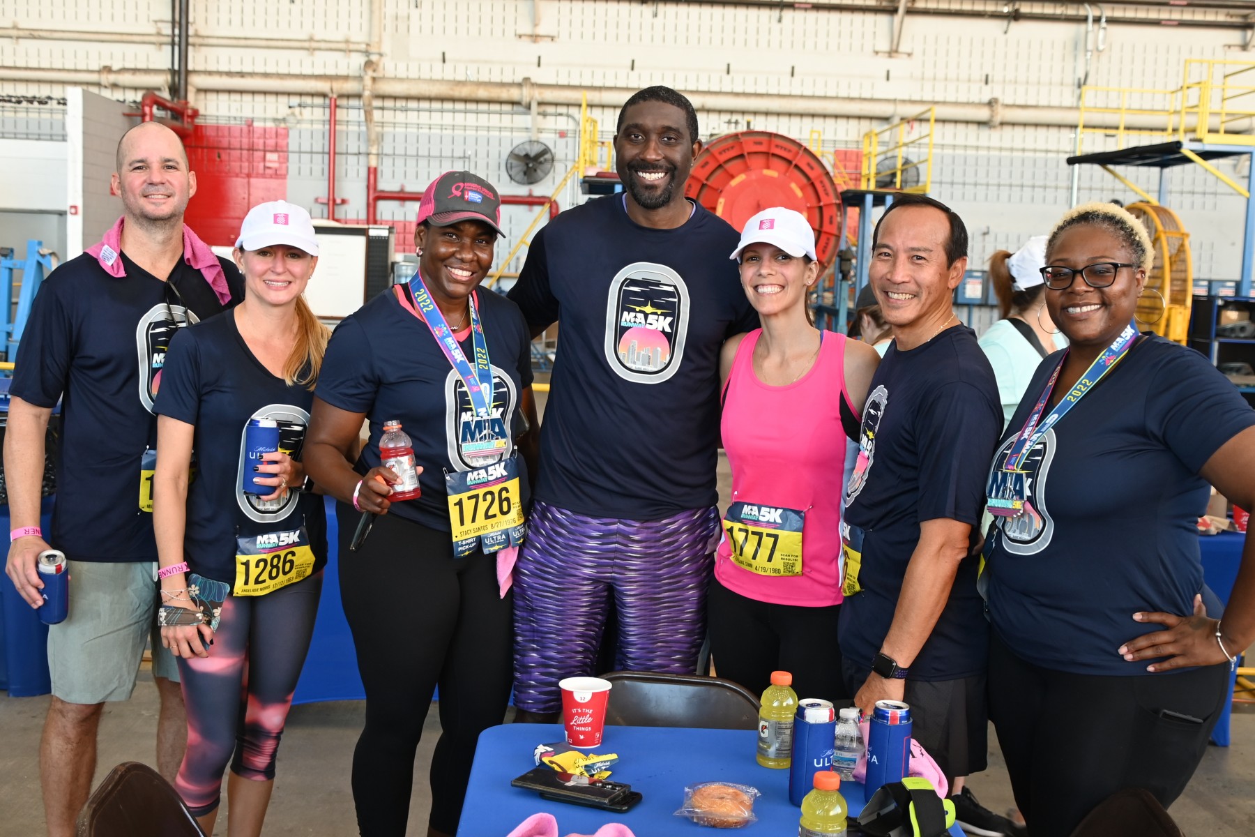 MIA Runway 5K participants with their medals.