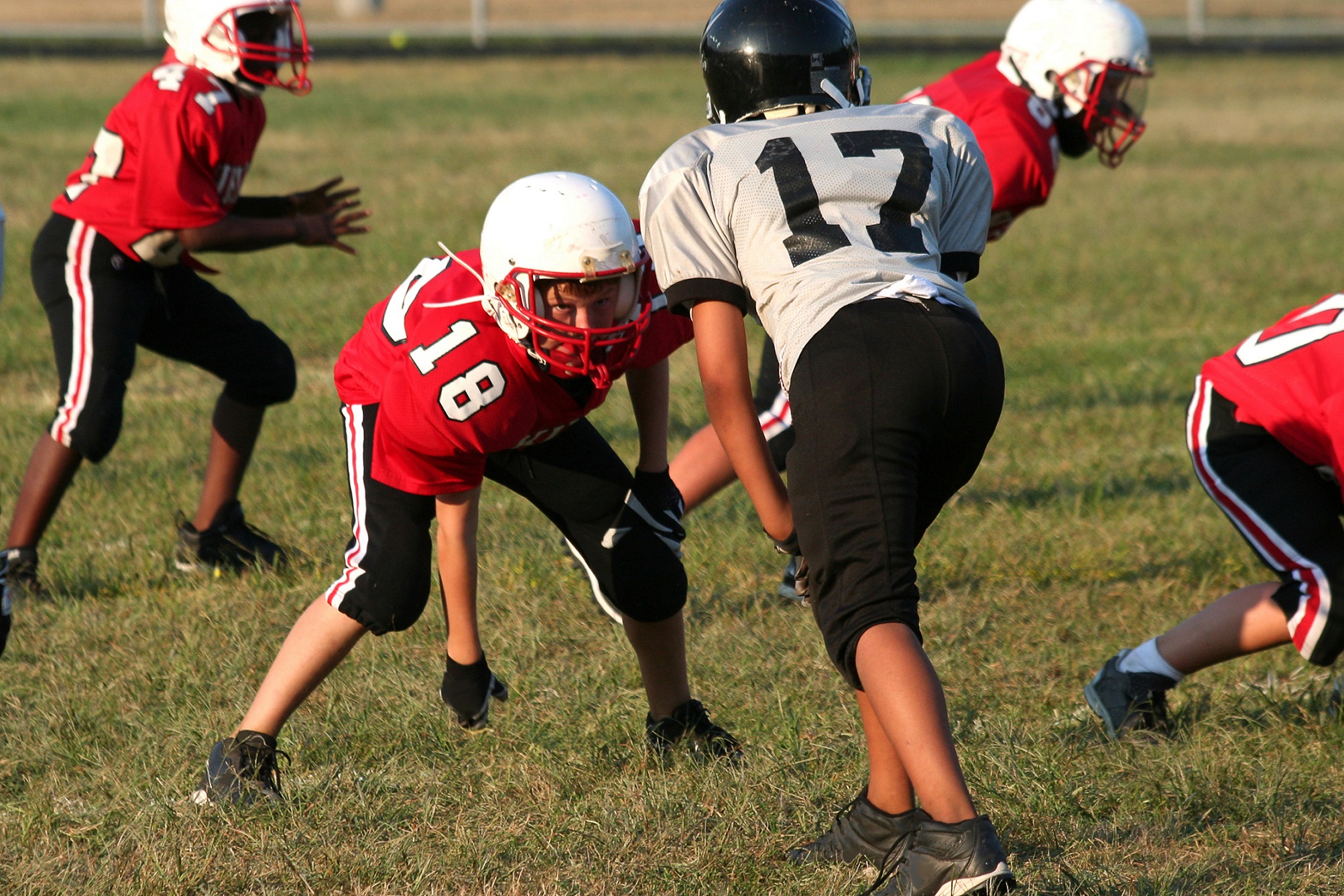 Americans love football, but differ on whether kids should play