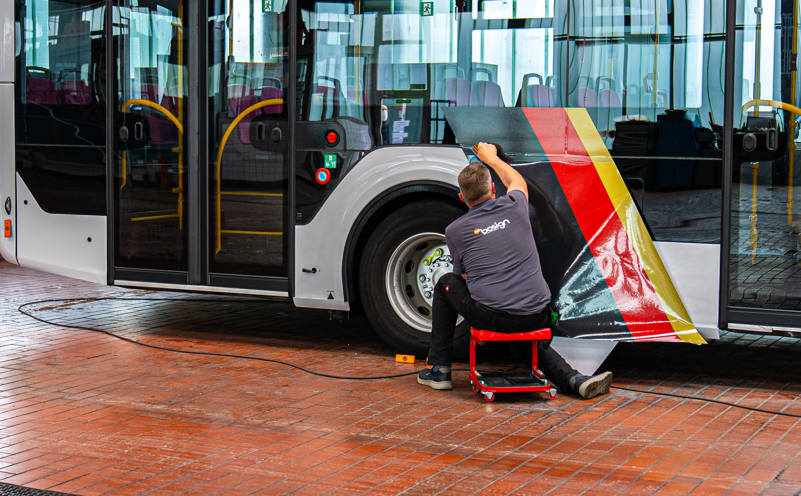 Germany is powered by MAN! Buses featuring a black, red and gold design ...